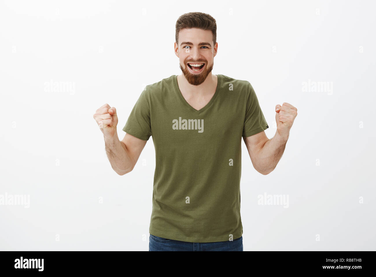 Come on you can do it. Active and excited happy handsome man with beard ...