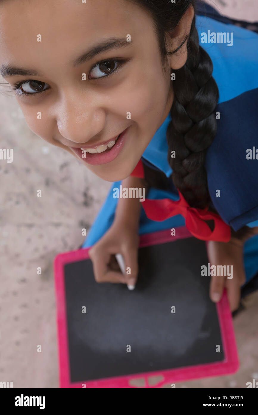 Close up of rural school girl writing on slate Stock Photo - Alamy