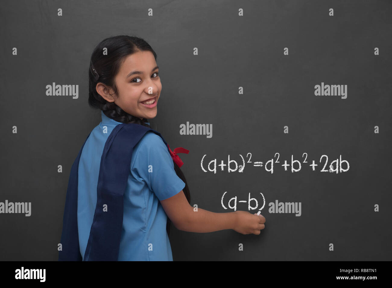 Rural school girl writing formula on a blackboard Stock Photo - Alamy