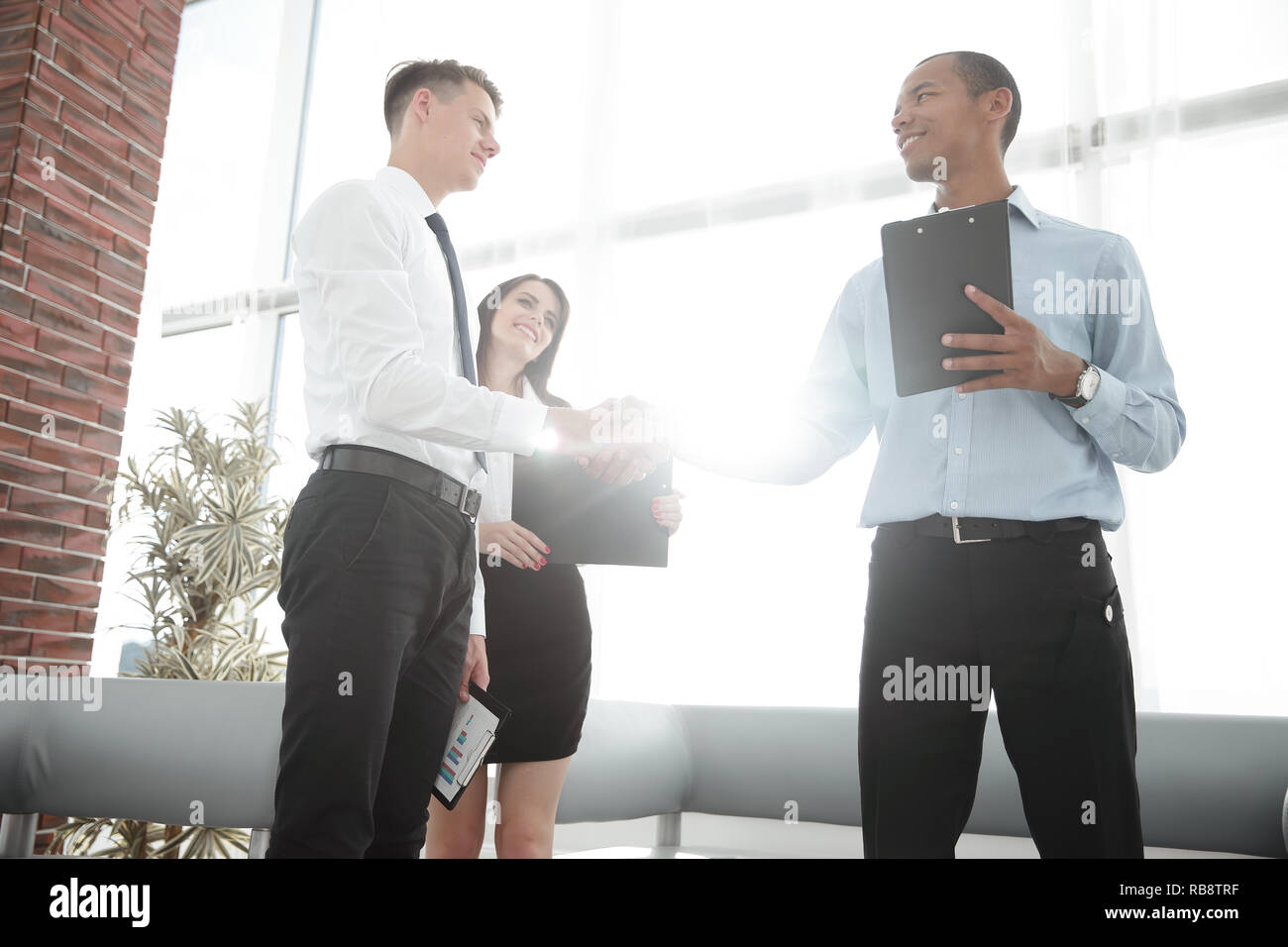handshake of business partners standing in the office Stock Photo - Alamy