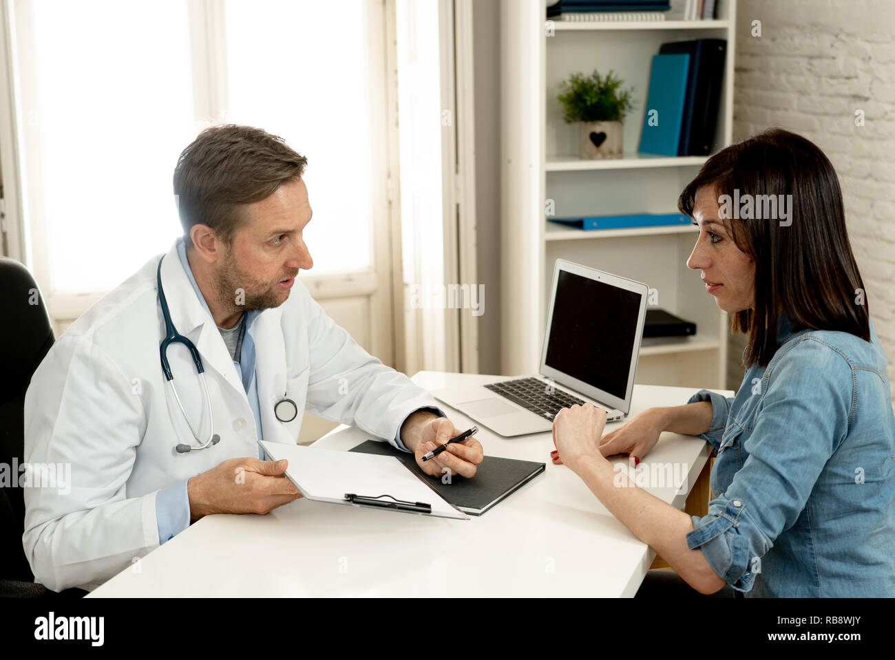 Professional doctor with grateful happy female patient having ...