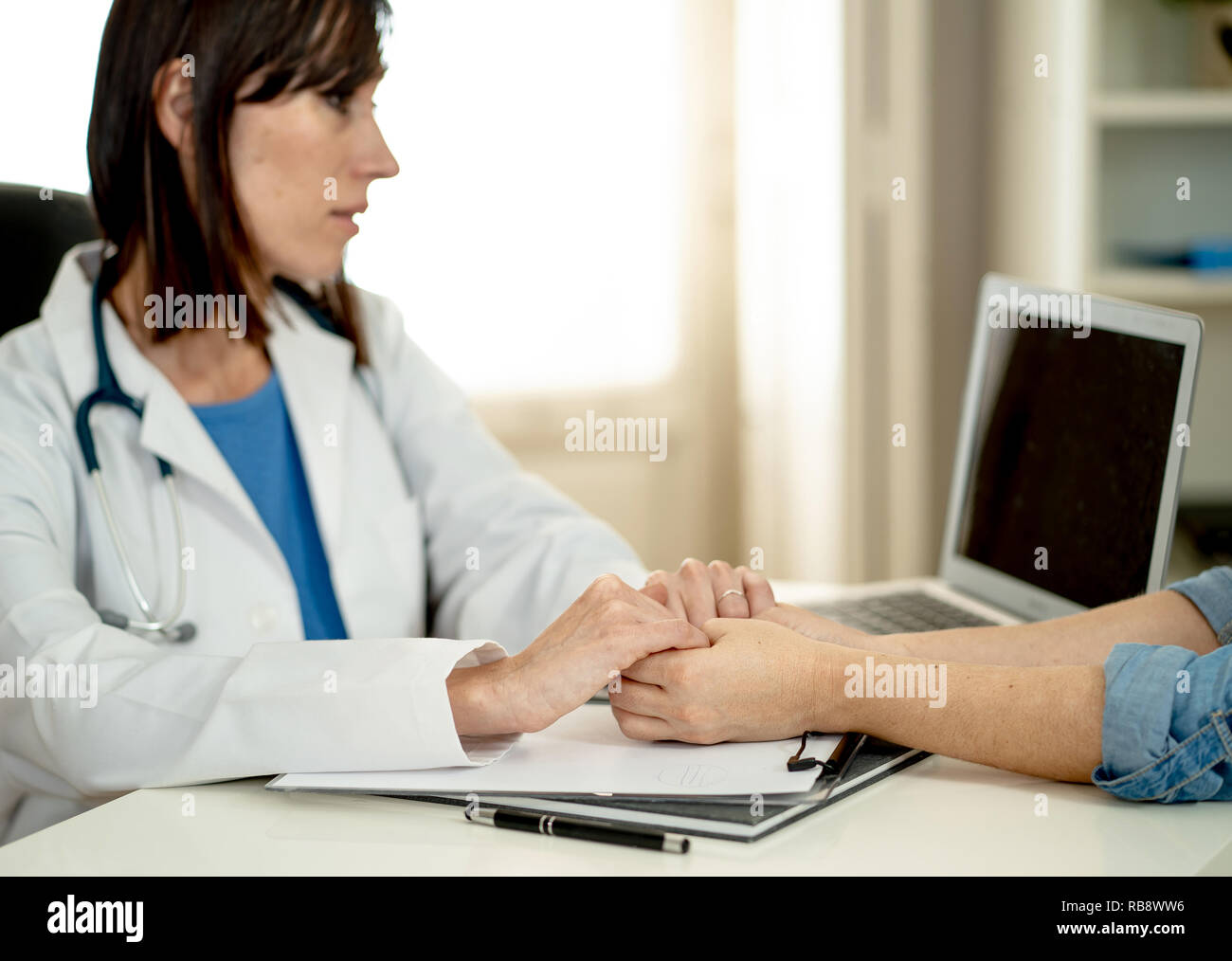 Female doctor discussing diagnosis with woman patient reassuring and ...