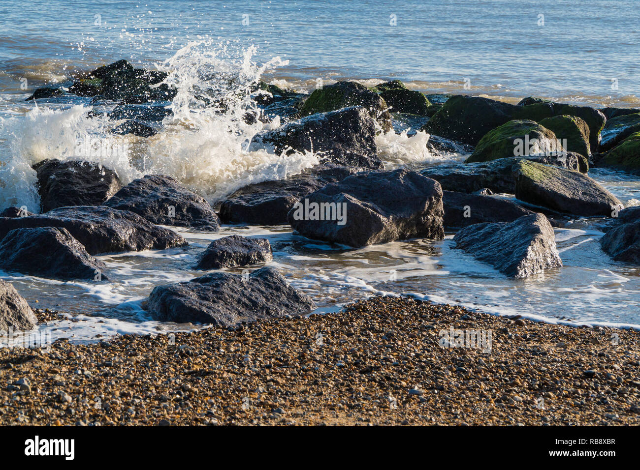 Surf breaking over rocks Clacton on Sea Essex England UK Stock Photo ...