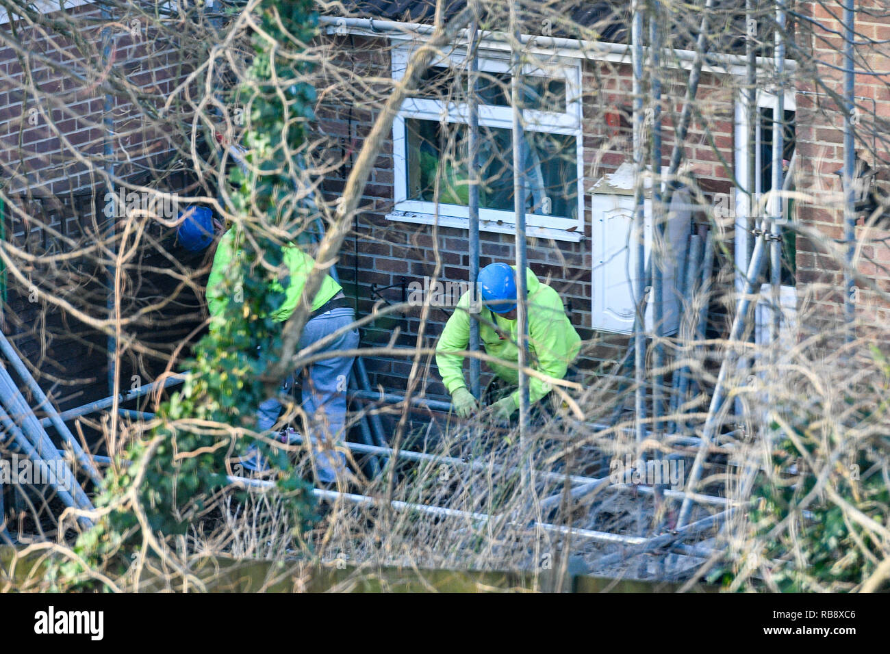 Contractors erect scaffolding behind the home of former Russian spy ...