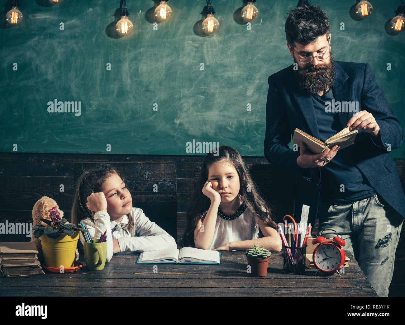 High school or college students studying and reading together in ...