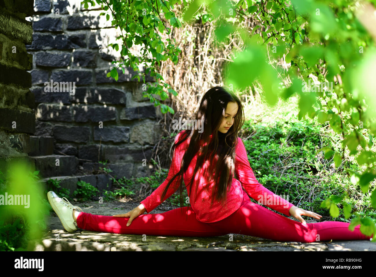 Feeling her inner thigh muscles work. Little girl doing split outdoor ...