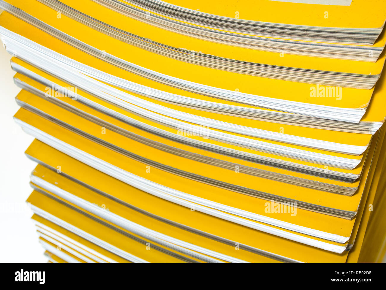 Stack of yellow color monthly magazine Stock Photo - Alamy