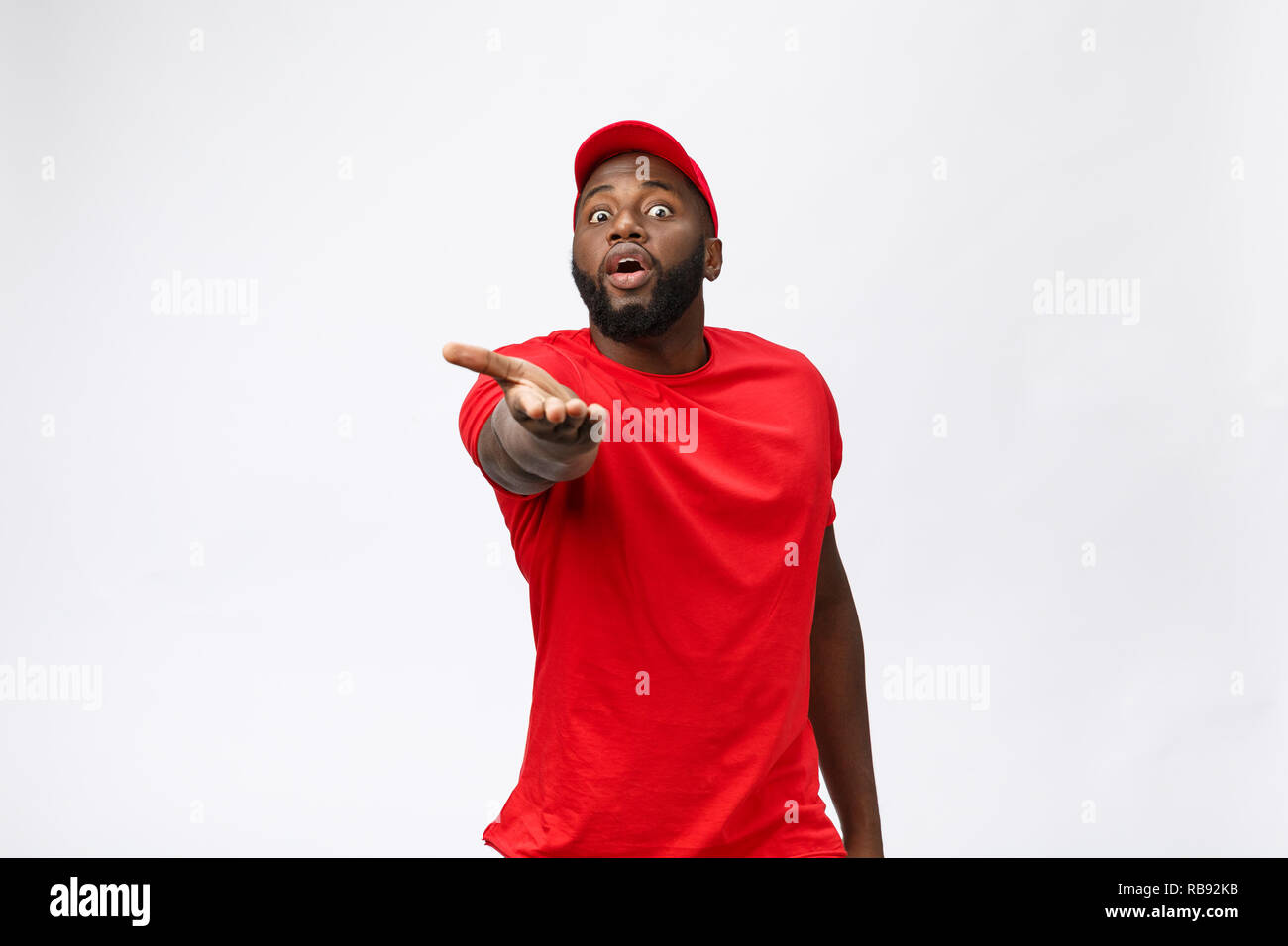 Young african american man with shocking face. Isolated over Grey ...
