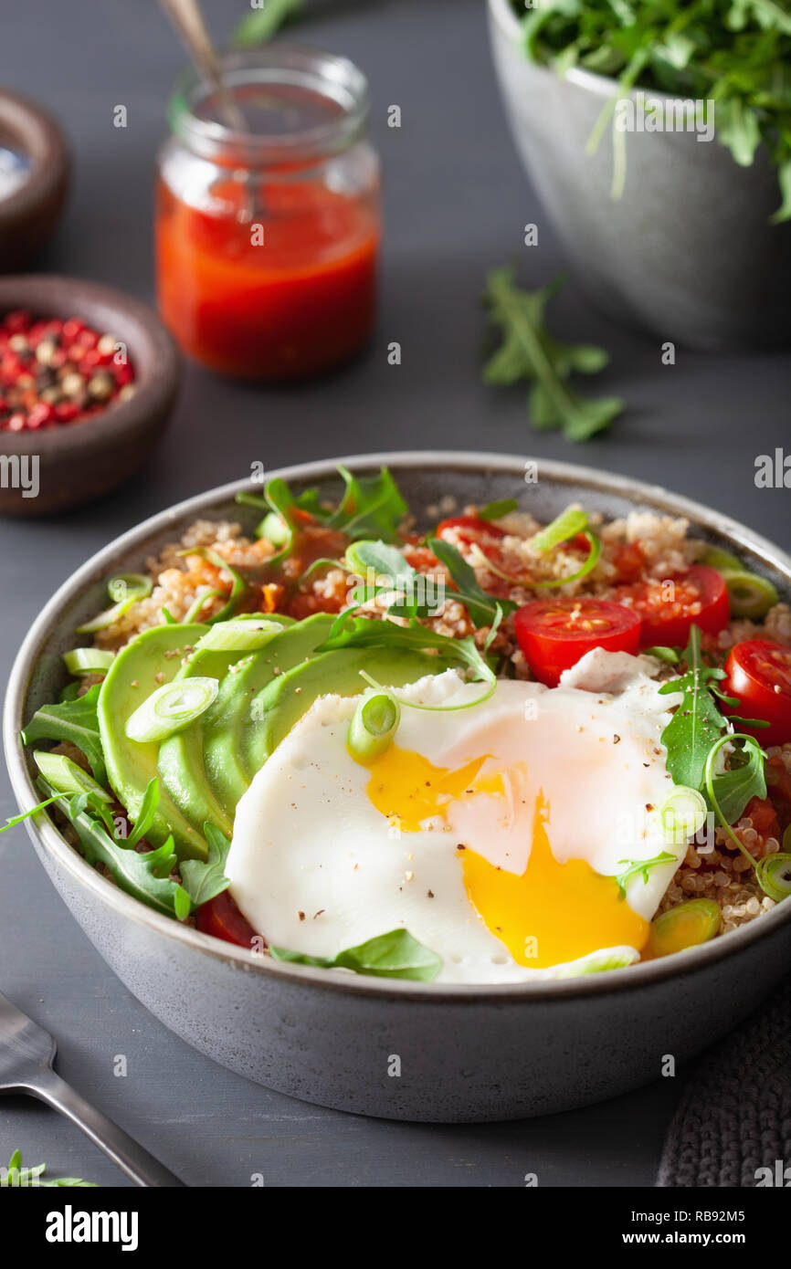 quinoa bowl with fried egg, avocado, tomato, rocket. Healthy vegetarian ...