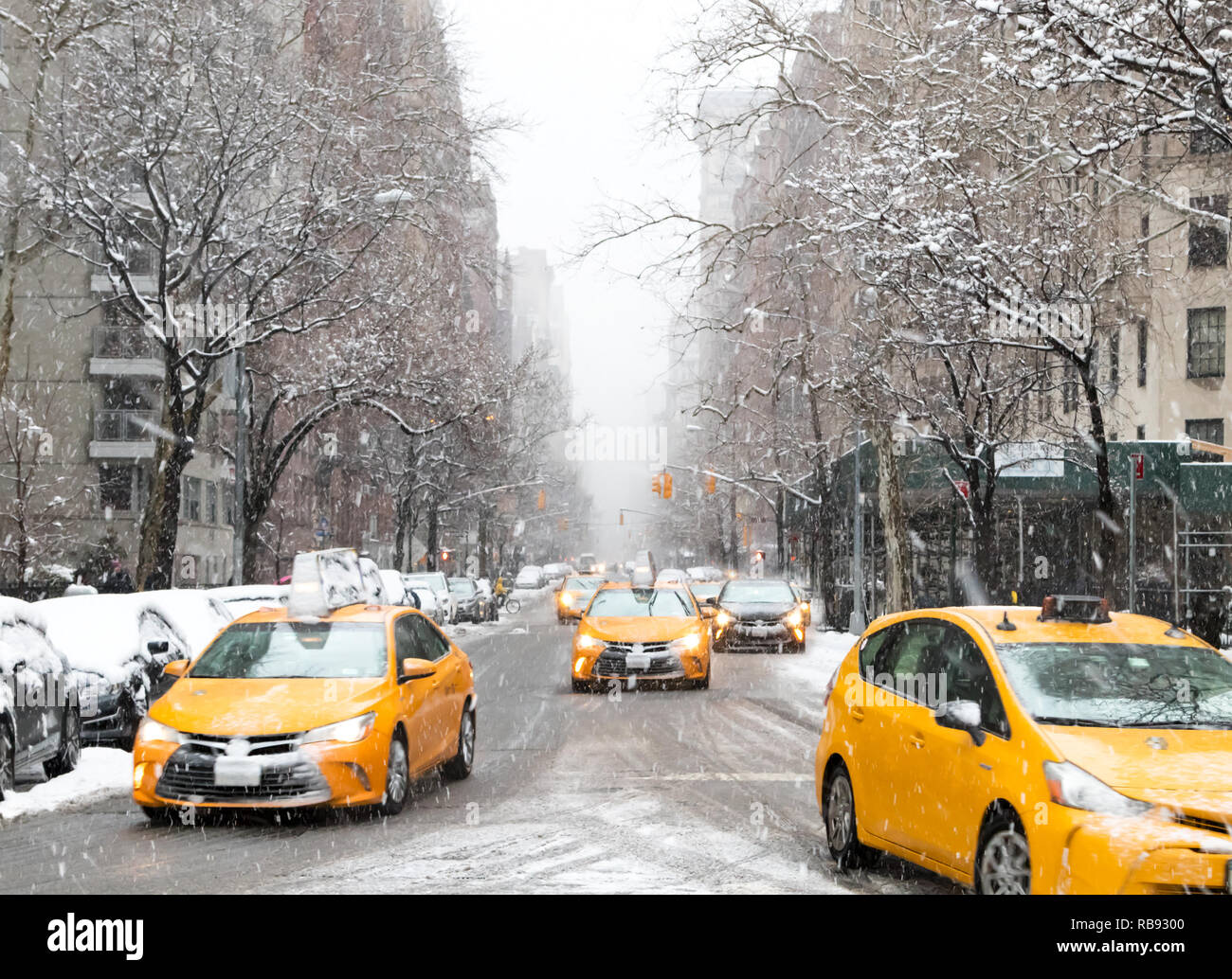 New York City taxis drive down Fifth Avenue through the snow during a ...