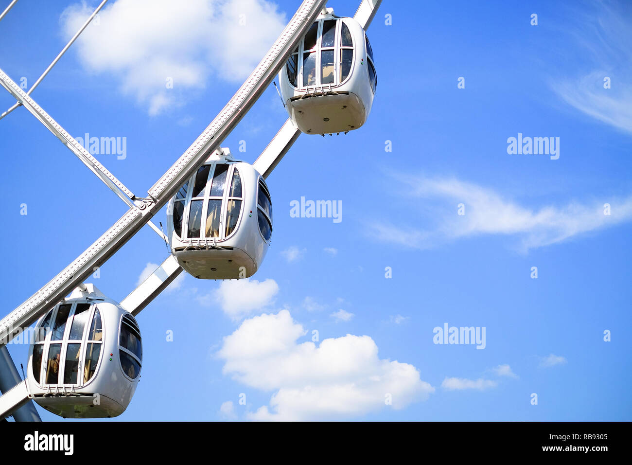 Amusement park. Ferris wheel. Cabs on a blue sky background. Landscape ...