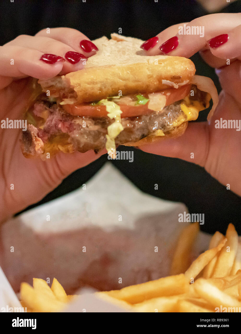 Bar Food: Bar Burger being consumed by patron. No identifible people ...