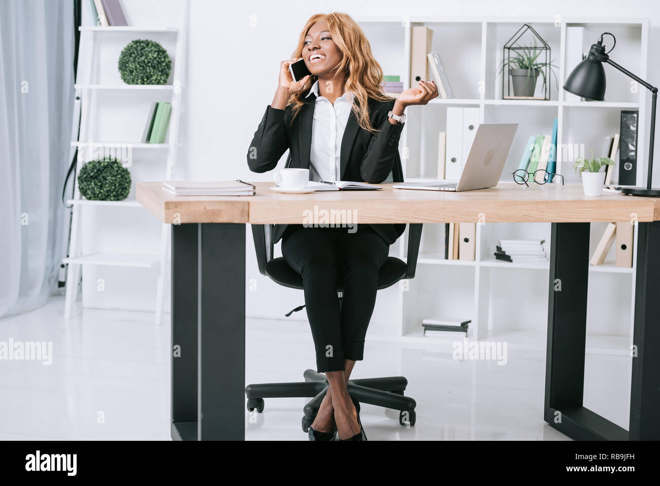 attractive african american businesswoman talking on smartphone and ...