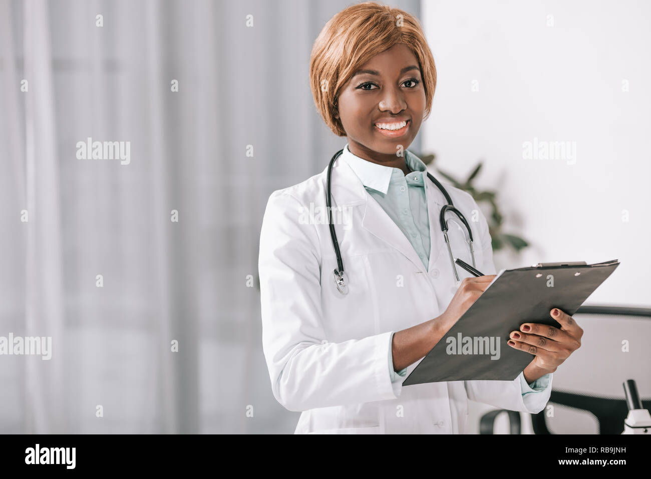 smiling african american doctor with stethoscope and clipboard Stock ...