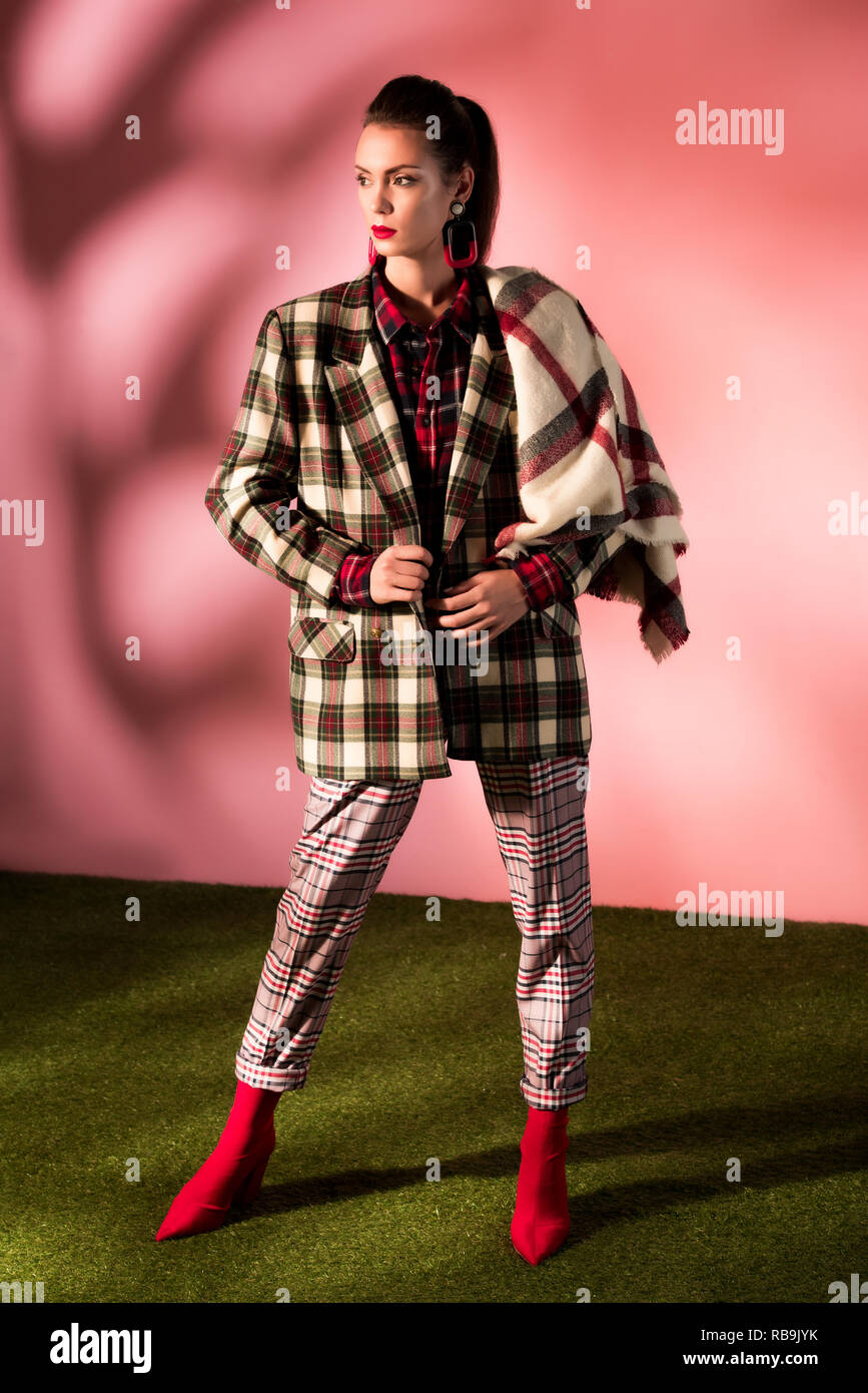 beautiful model posing in checkered suit on pink background Stock Photo ...