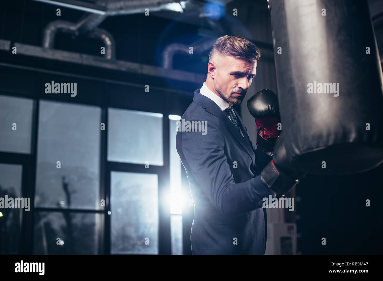 Punching bag man suit hi-res stock photography and images - Alamy