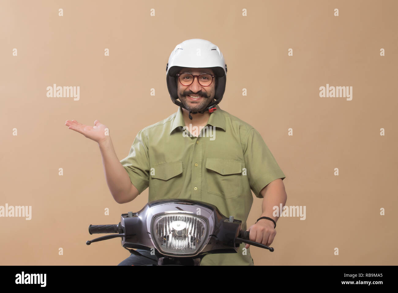 Indian man riding a scooter hi-res stock photography and images - Alamy