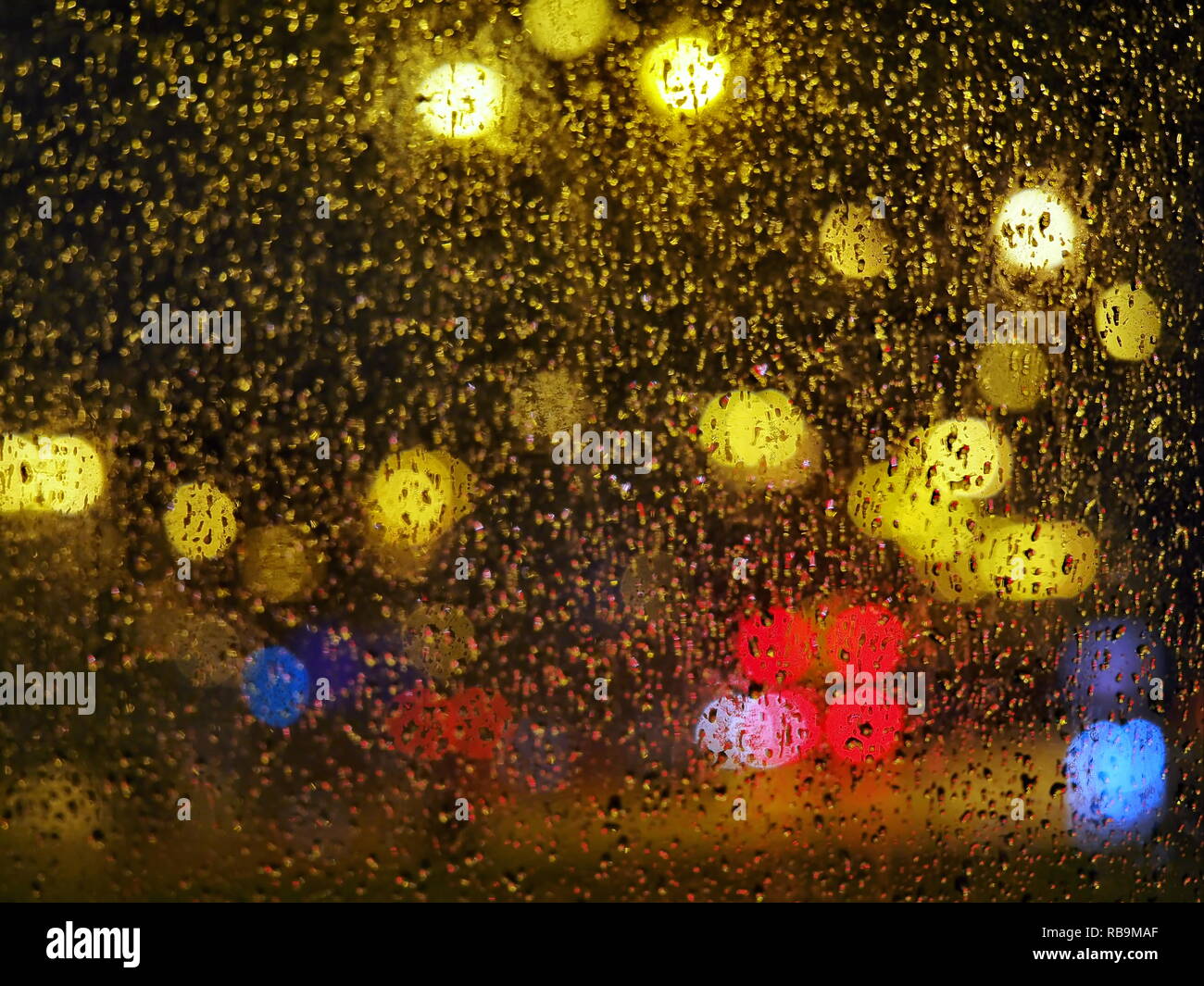 Rainy night from bus window focused rain drops blurry colorful street ...