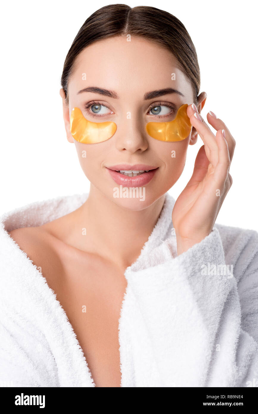 Beautiful Woman In White Bathrobe With Golden Eye Patches Isolated On