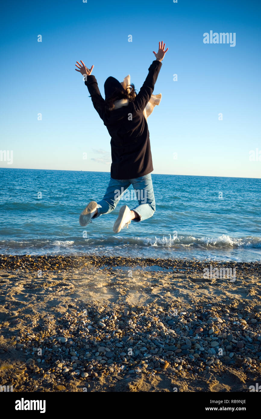 Woman celebrating jumping winter hi-res stock photography and images ...