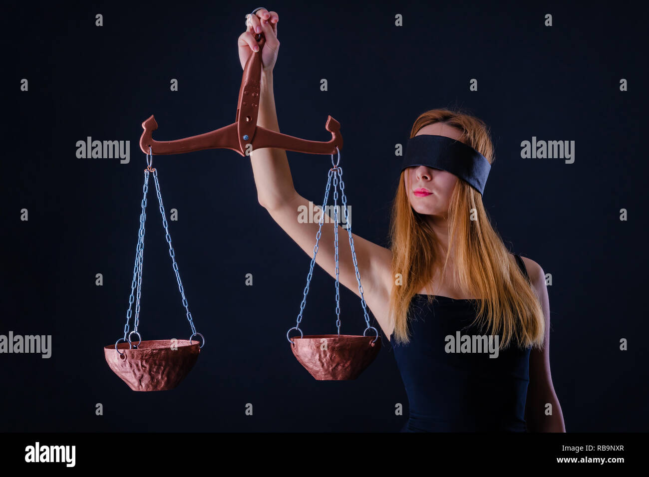 Charming girl with Libra in her hand as a symbol of the air zodiac sign ...