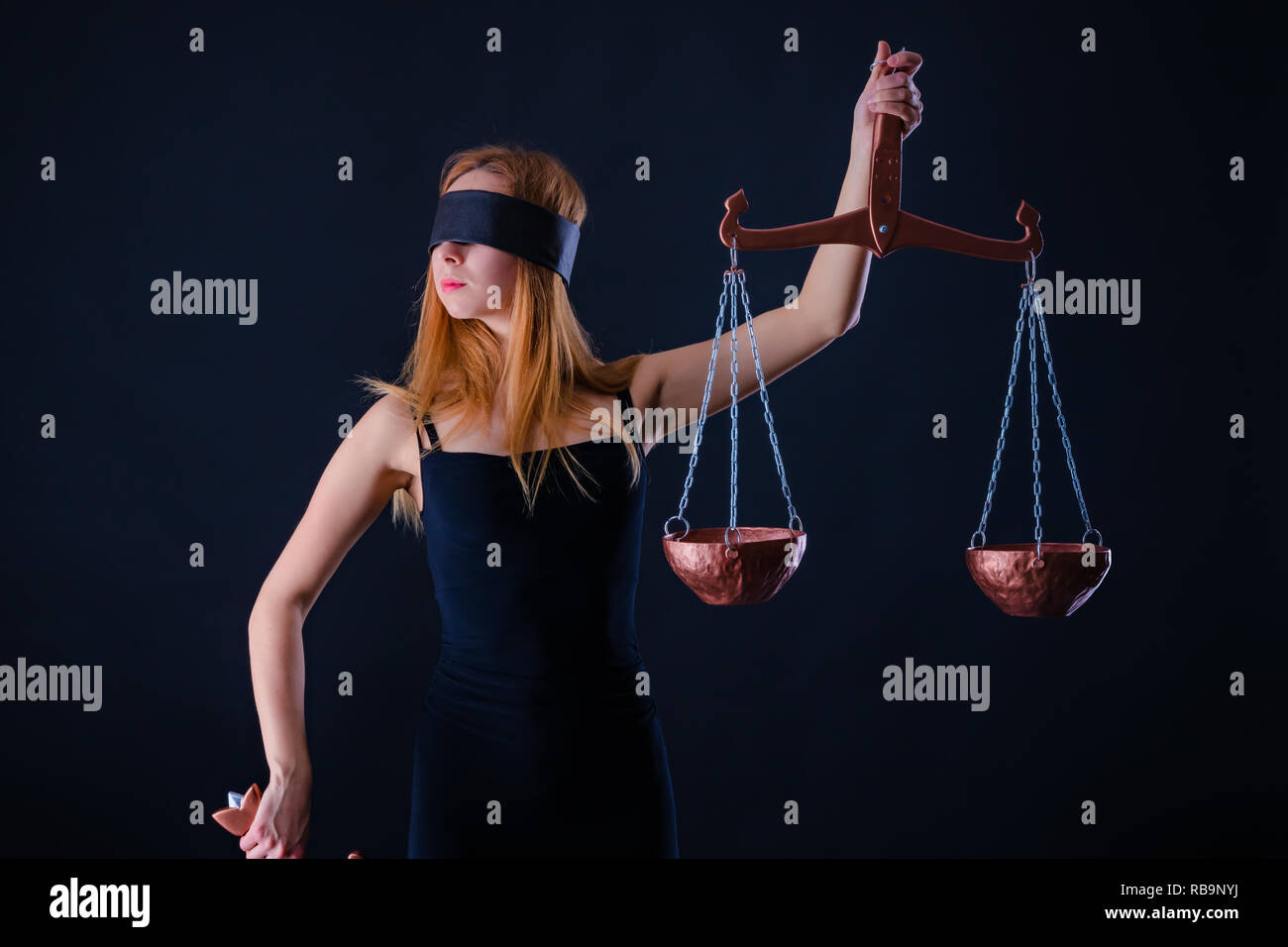 Charming girl with Libra in her hand as a symbol of the air zodiac sign ...