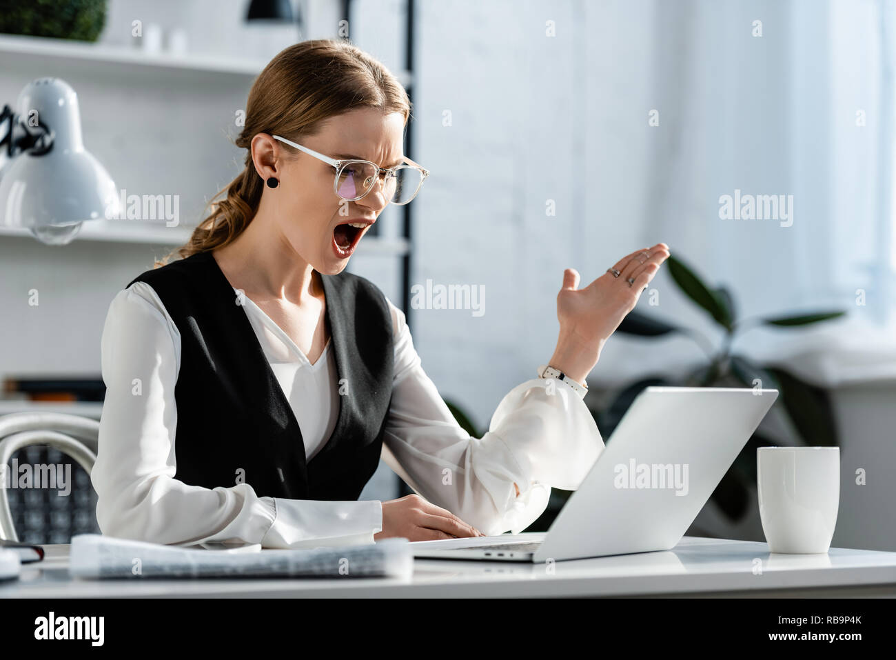 Businesswoman yelling desk hi-res stock photography and images - Alamy