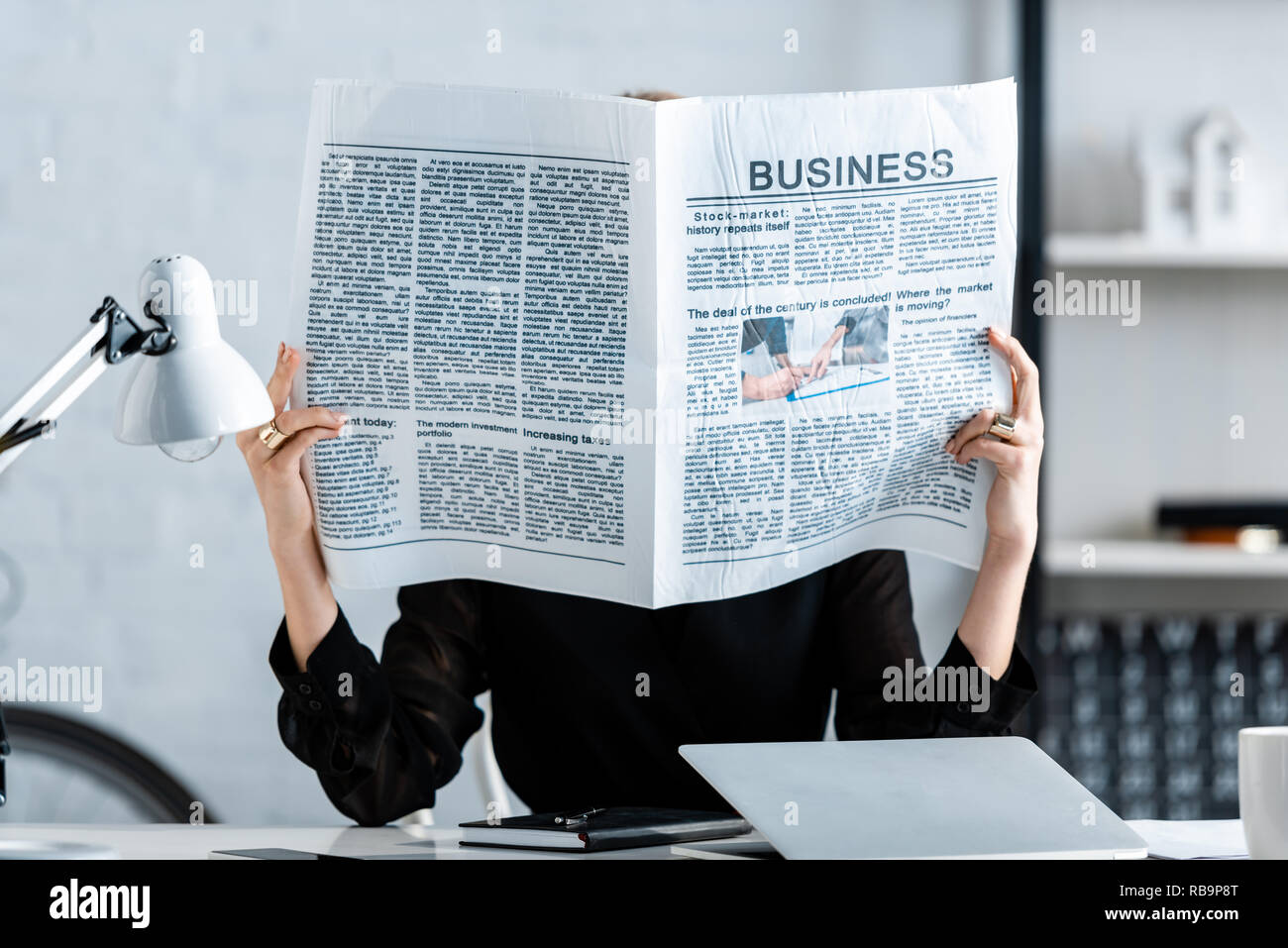 businesswoman reading newspaper and hiding face Stock Photo - Alamy
