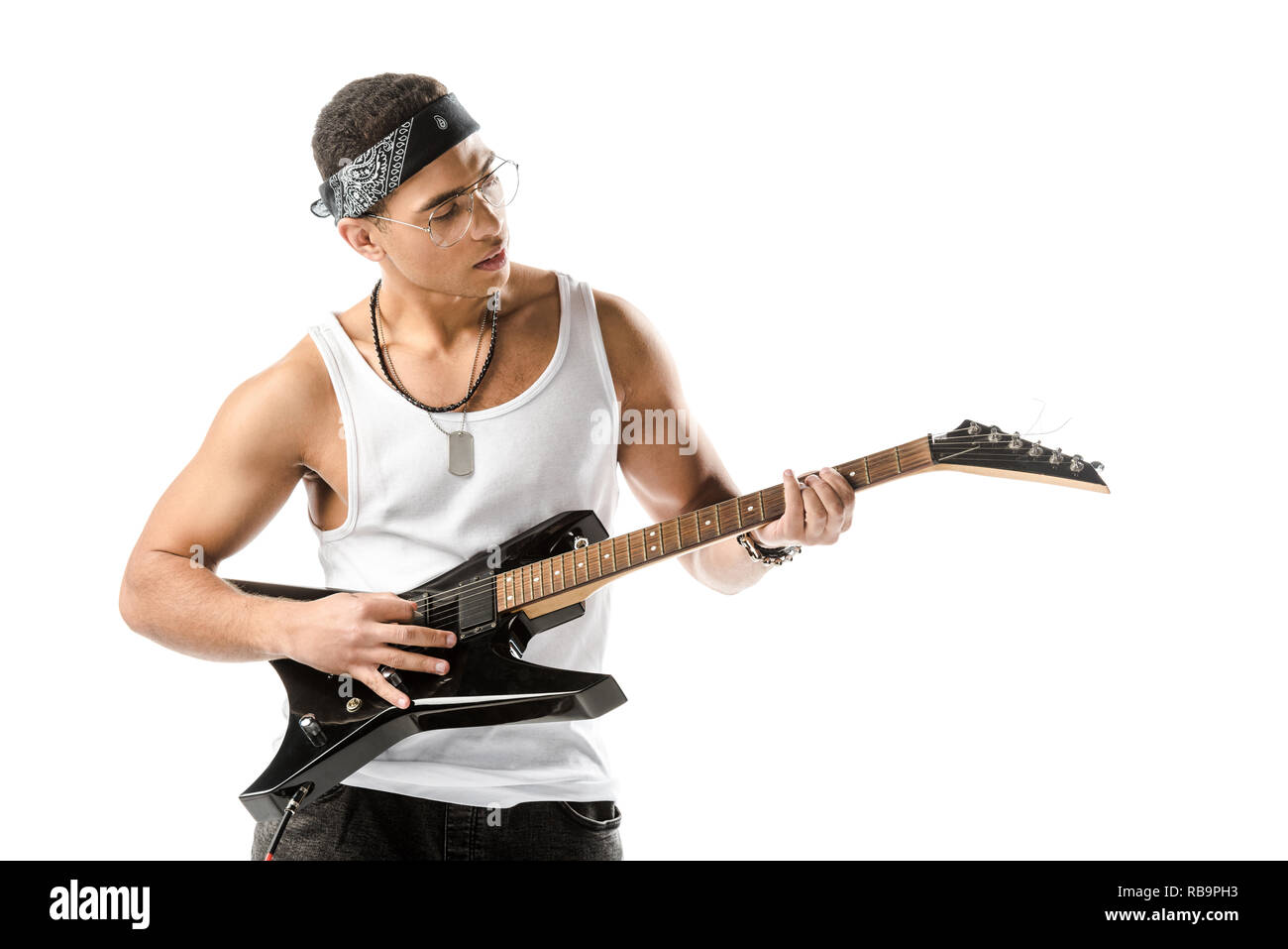 focused mixed race male rock musician playing on electric guitar ...