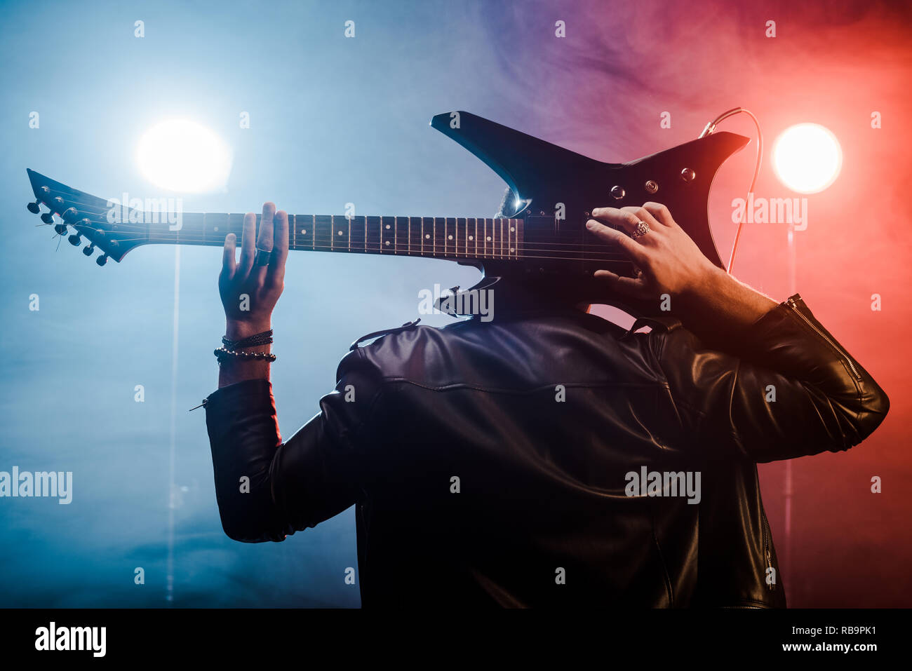Playing guitar behind head hi-res stock photography and images - Alamy