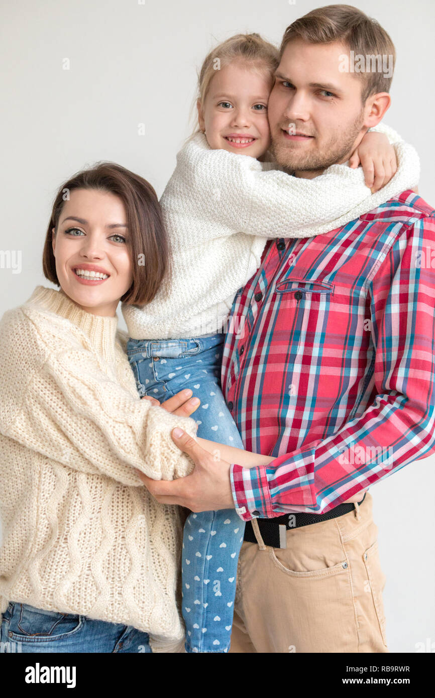 Cheerful family of three on white background Stock Photo - Alamy