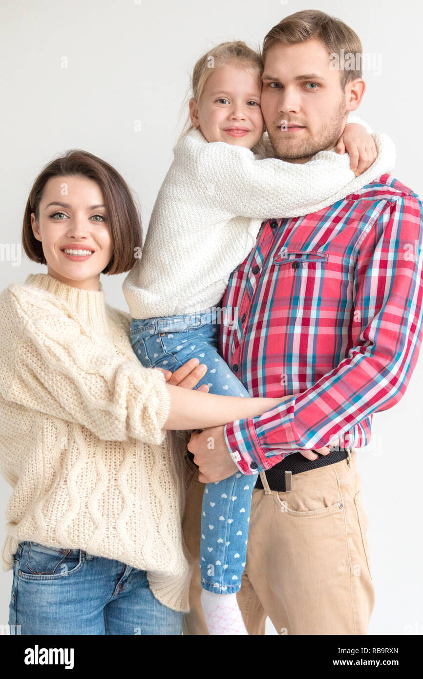 Cheerful family of three on white background Stock Photo - Alamy