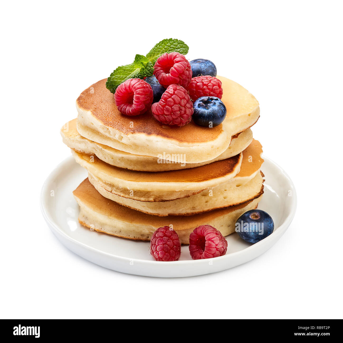 Stack of delicious pancakes with berries and mint leaf on plate ...