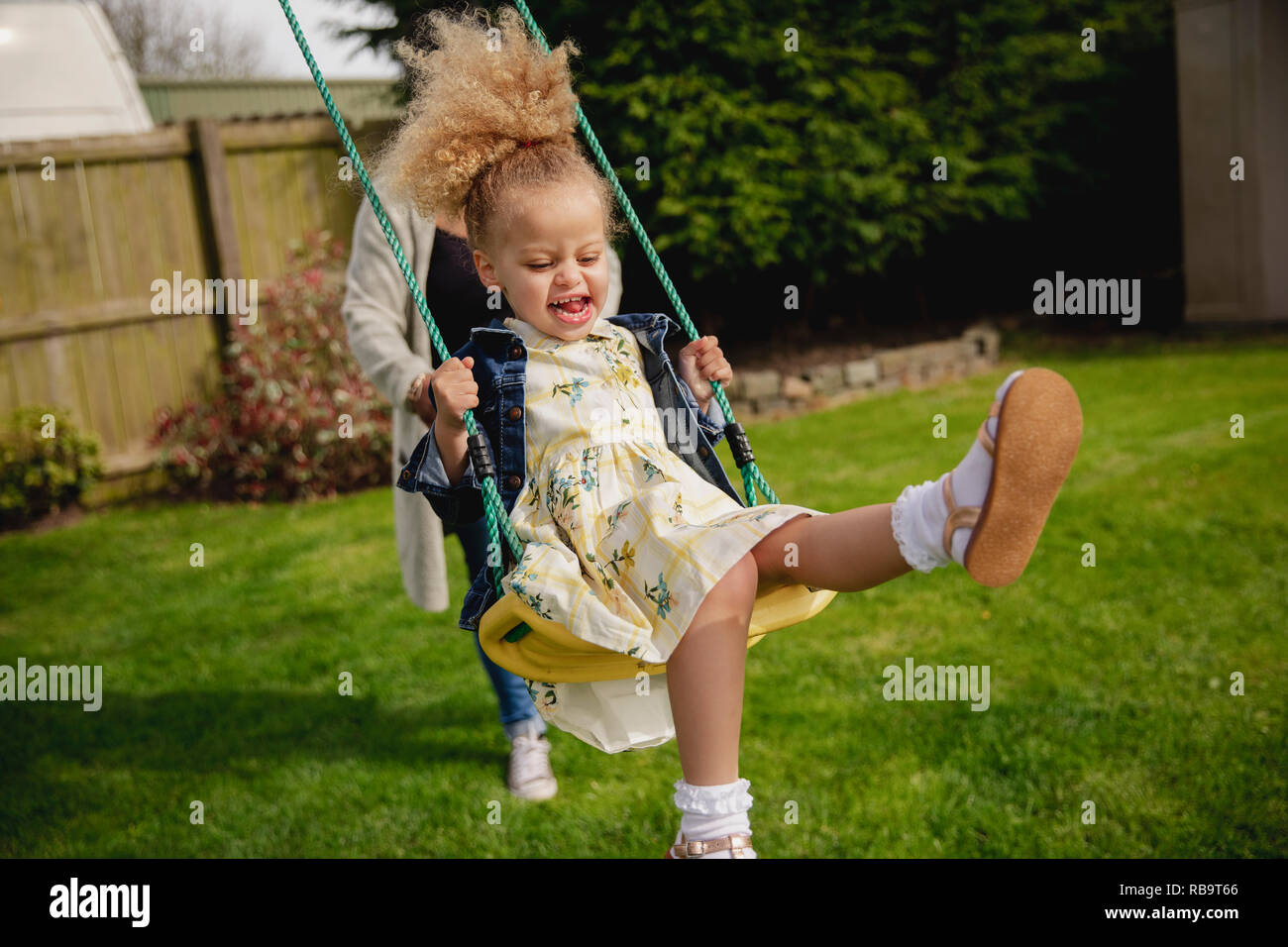 Pushed child on swing hi-res stock photography and images - Alamy