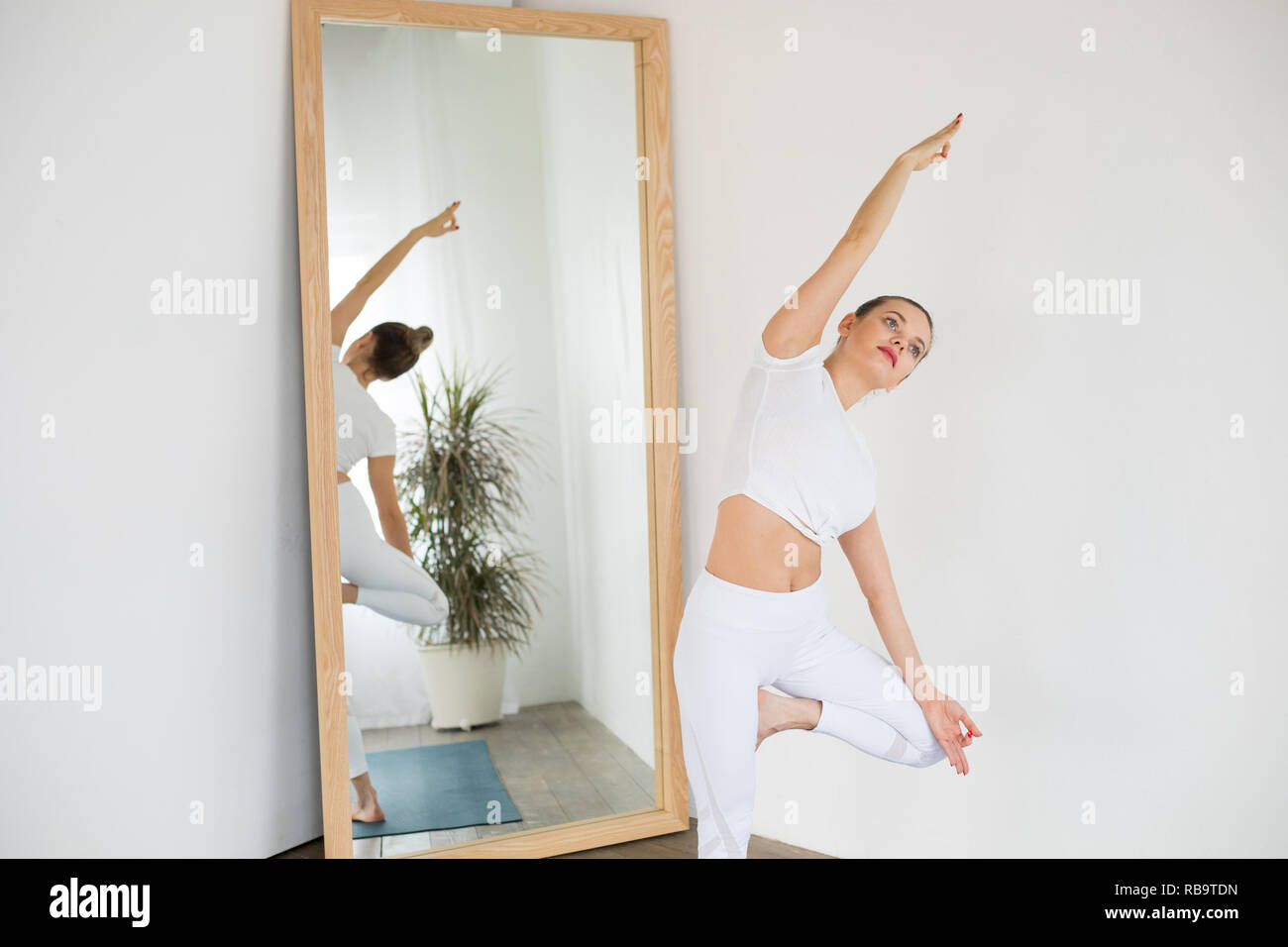 Female doing yoga in mirror hi-res stock photography and images - Alamy