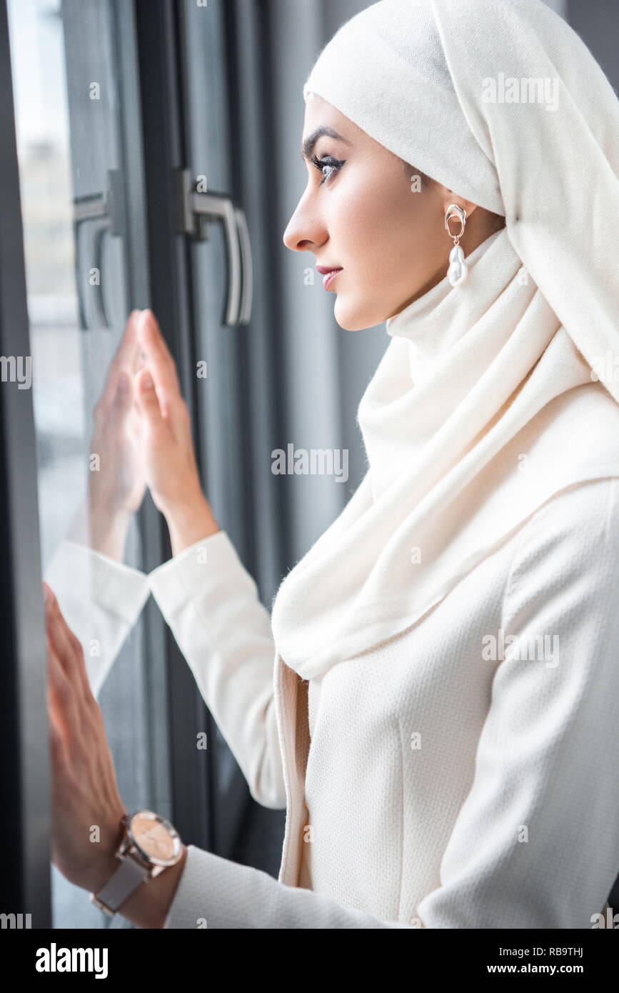side view of young muslim woman looking at window Stock Photo - Alamy