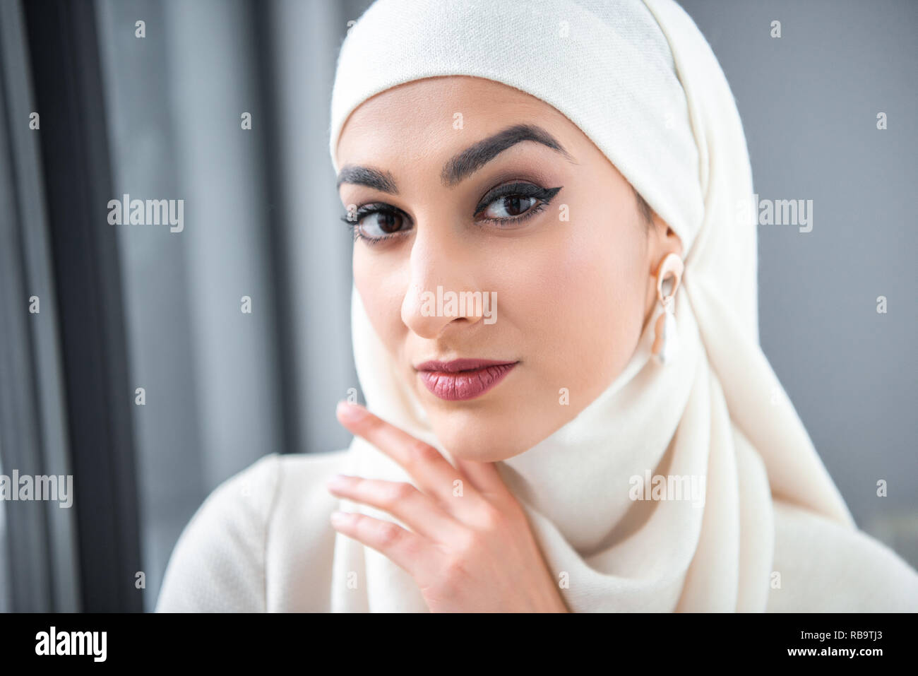 close-up portrait of beautiful young muslim woman looking at camera ...