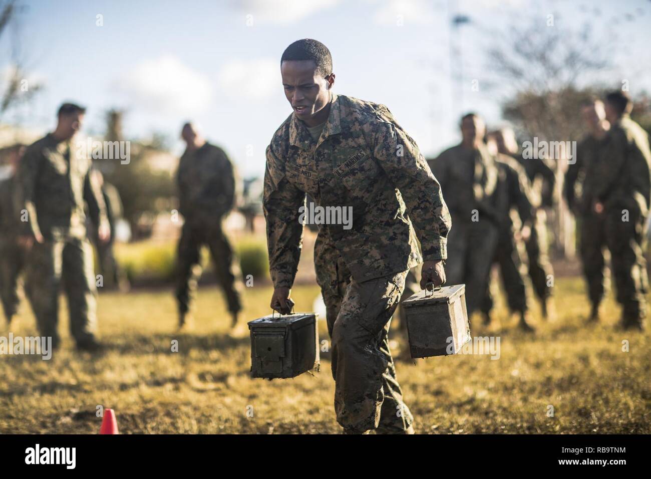 A Marine with Marine Forces Reserve sprints with two ammo cans during ...