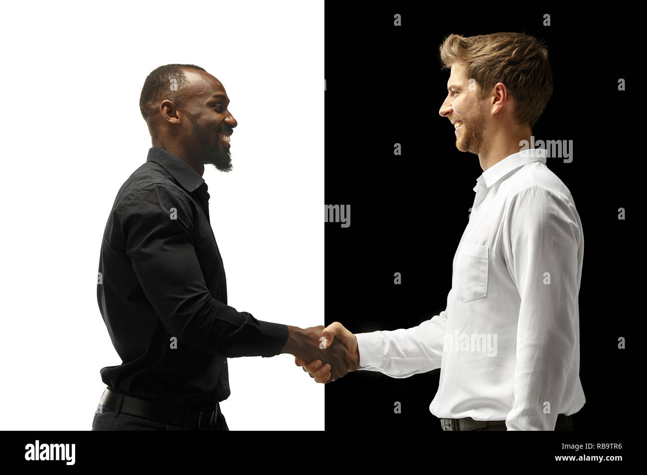 friendly handshake.The success happy afro and caucasian men. Mixed ...