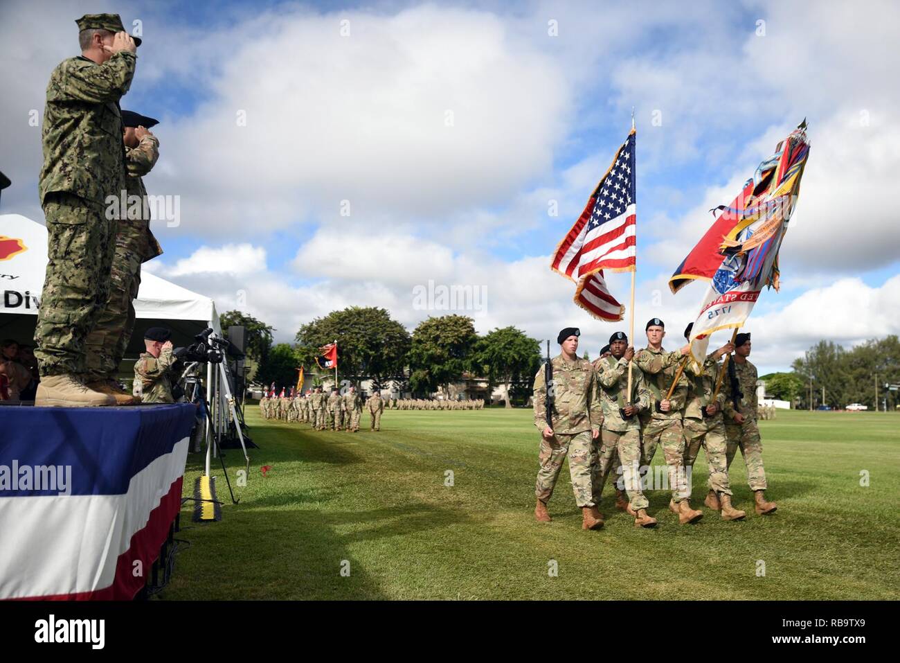 25th Infantry Division Soldiers bearing the national colors march past ...