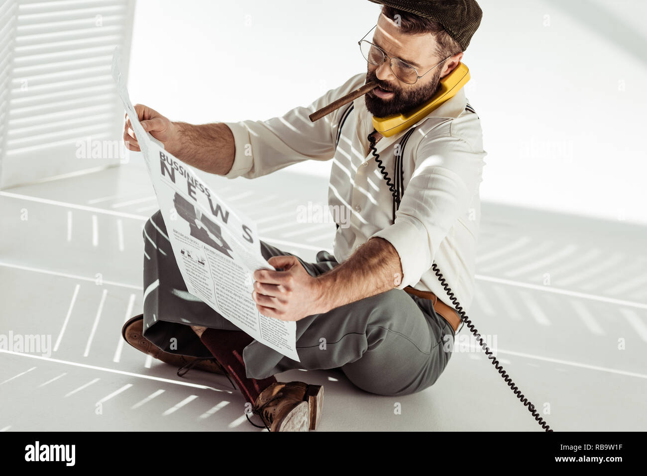 Smoking cigar and reading newspaper hi-res stock photography and images ...