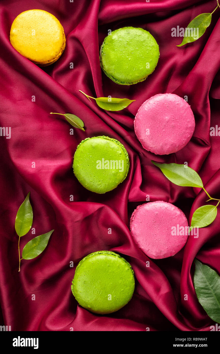 Colorful various French sweet macaroons dessert cake macarons on red ...