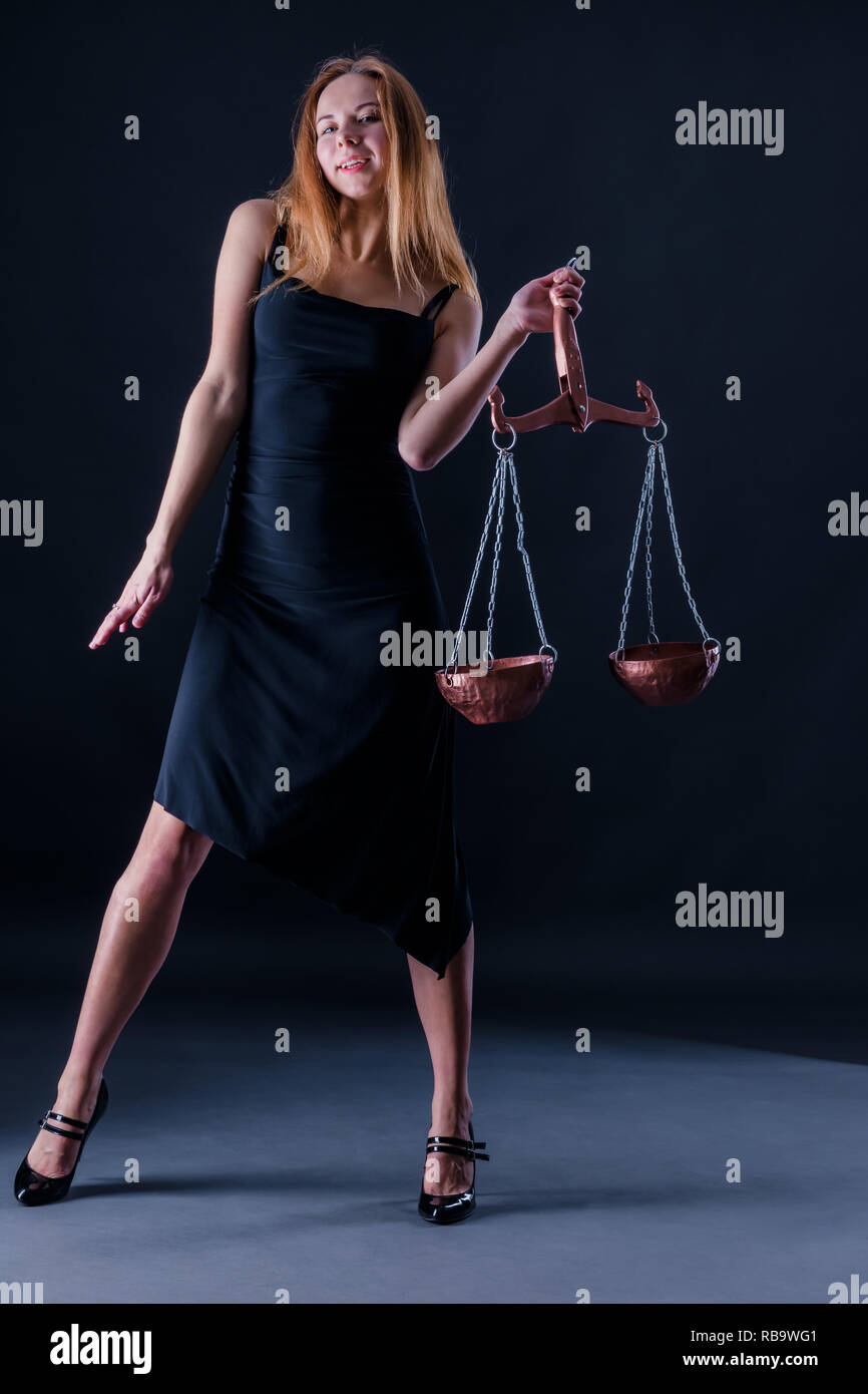 Attractive beautiful girl with Libra in hand as a symbol of the air ...