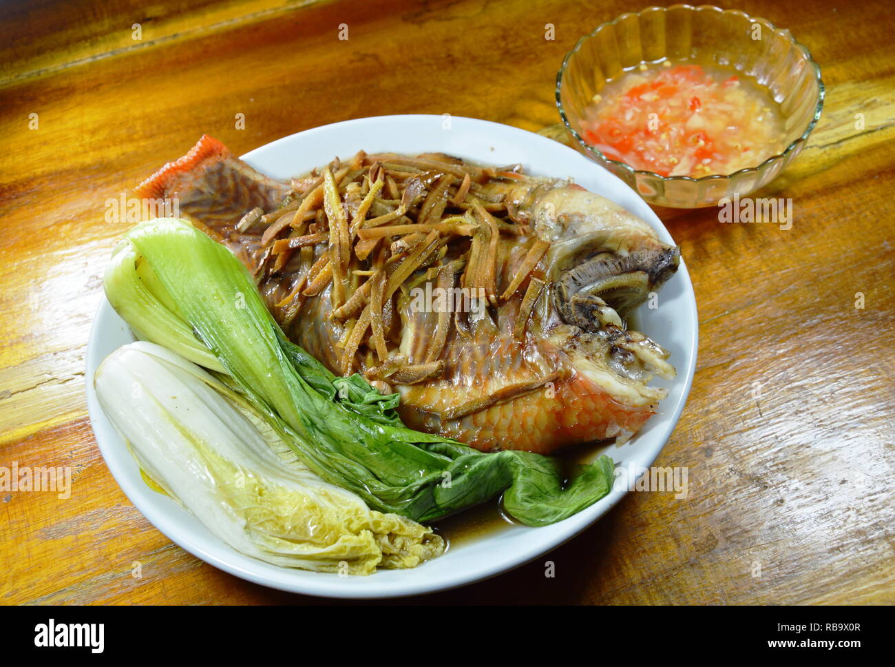 steamed red mango fish with vegetable topping slice ginger dipping ...