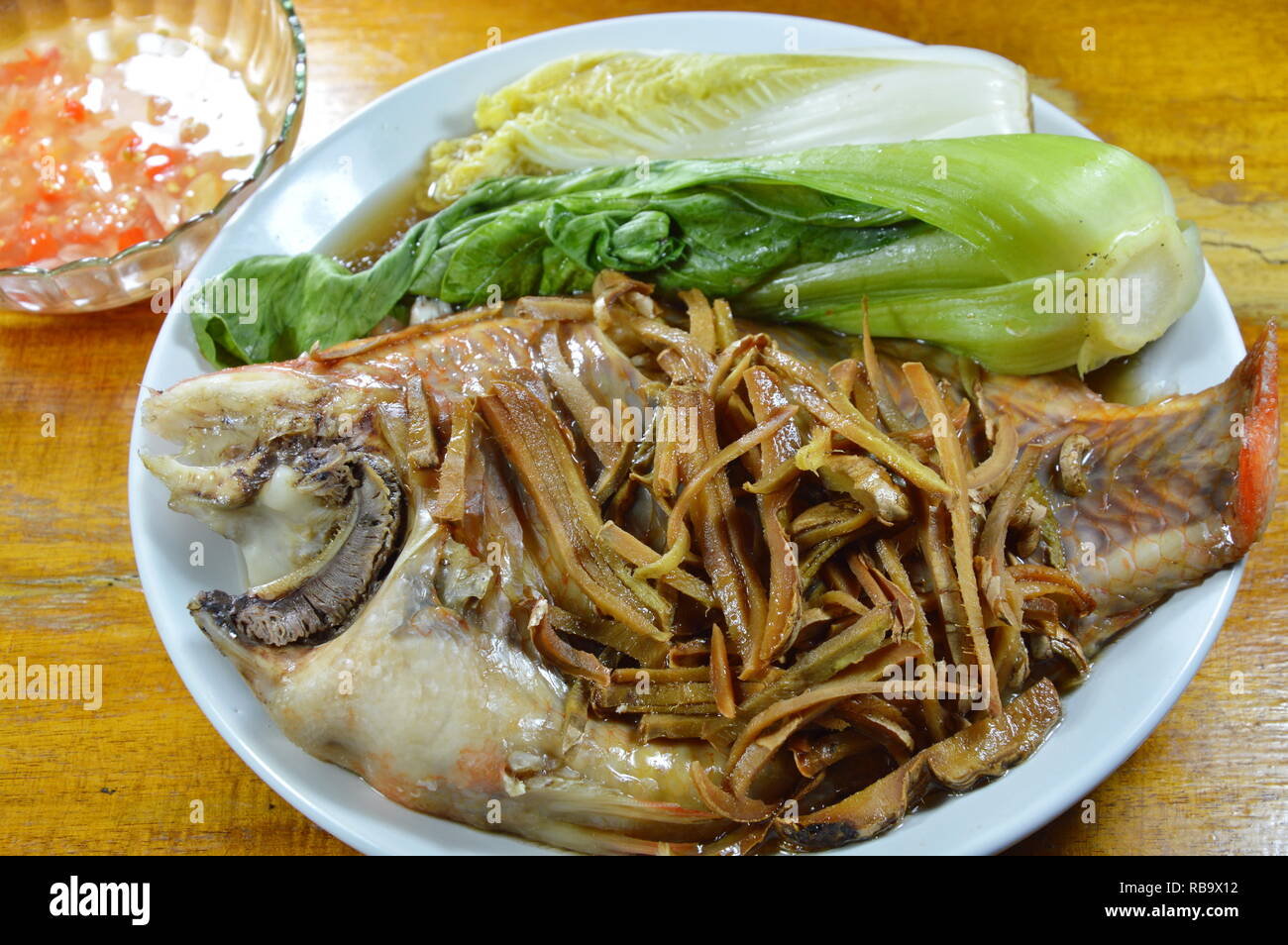 steamed red mango fish with vegetable topping slice ginger dipping ...
