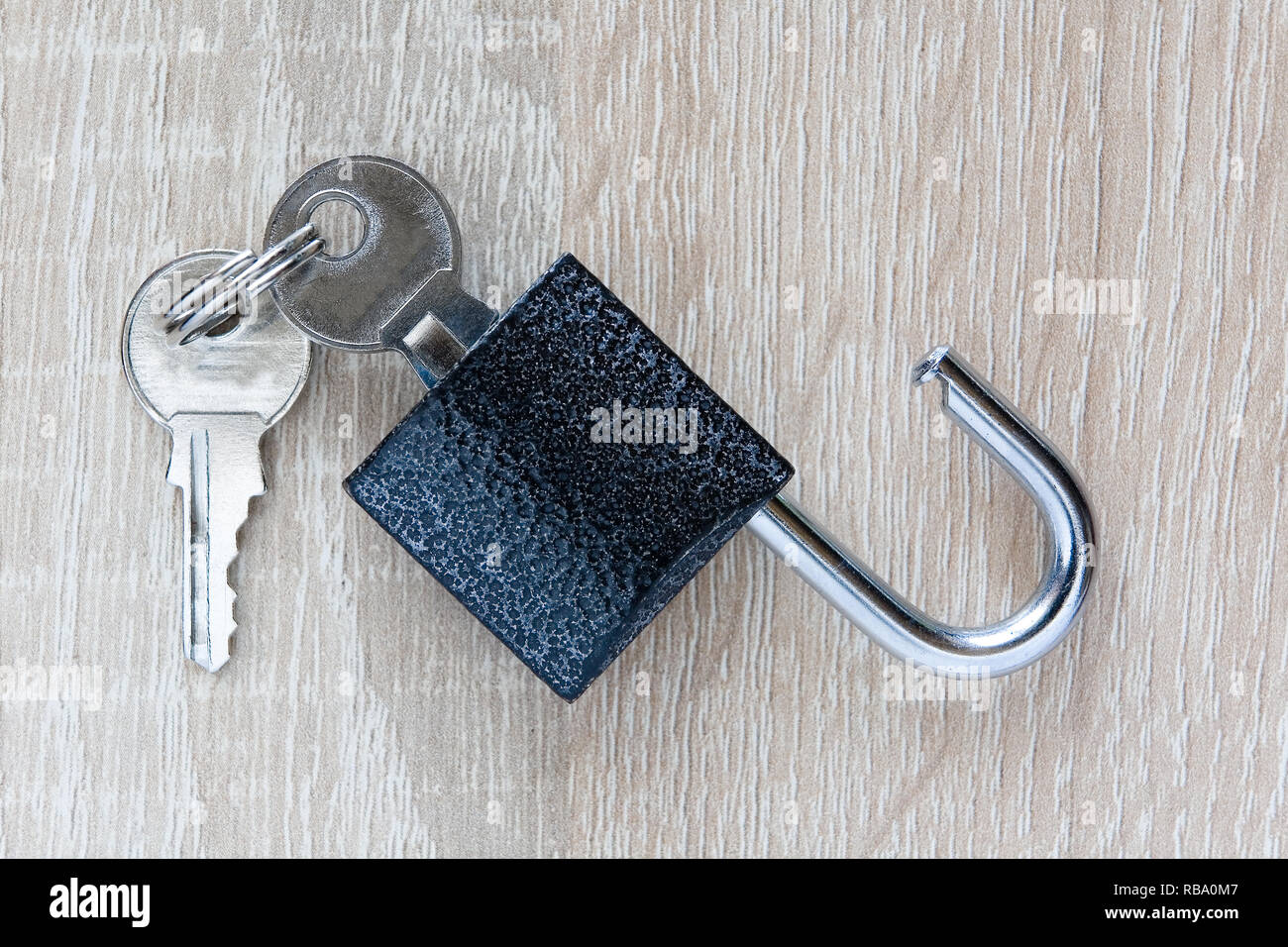 The key is inserted in the padlock. The lock is open Stock Photo - Alamy