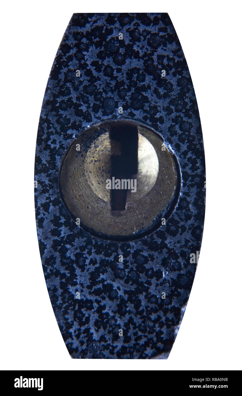 Keyhole of the metal lock is photographed close-up. On a white ...