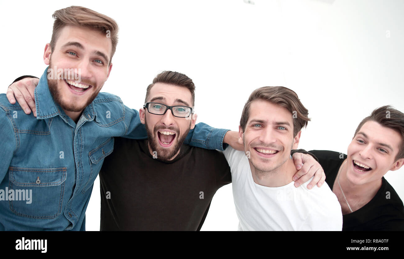 Four cheerful young guys stand and hug Stock Photo - Alamy