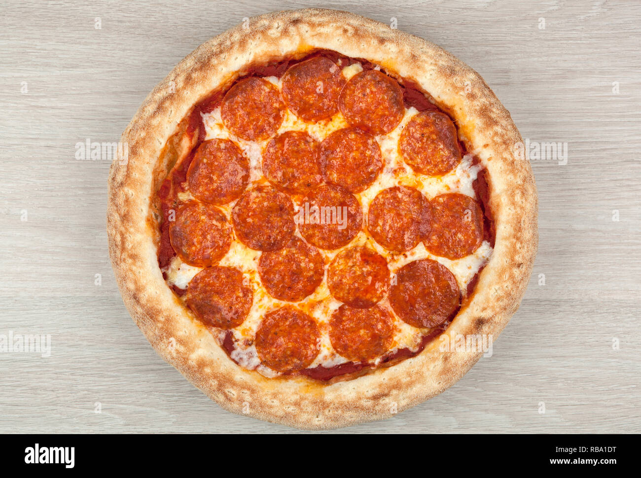 round fresh hot pepperoni pizza with sausage Stock Photo - Alamy
