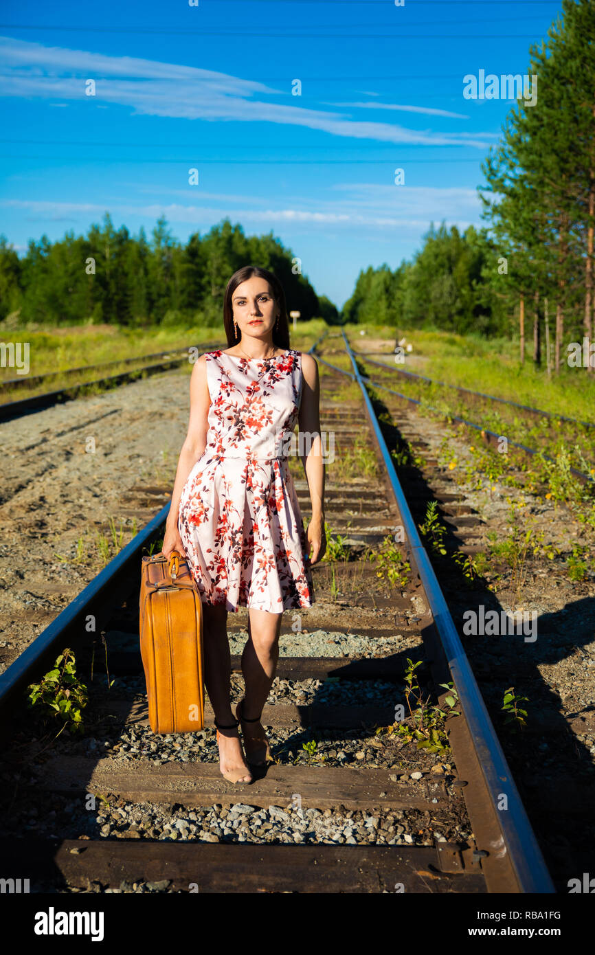 girl on the tracks waiting for the train and travel Stock Photo - Alamy